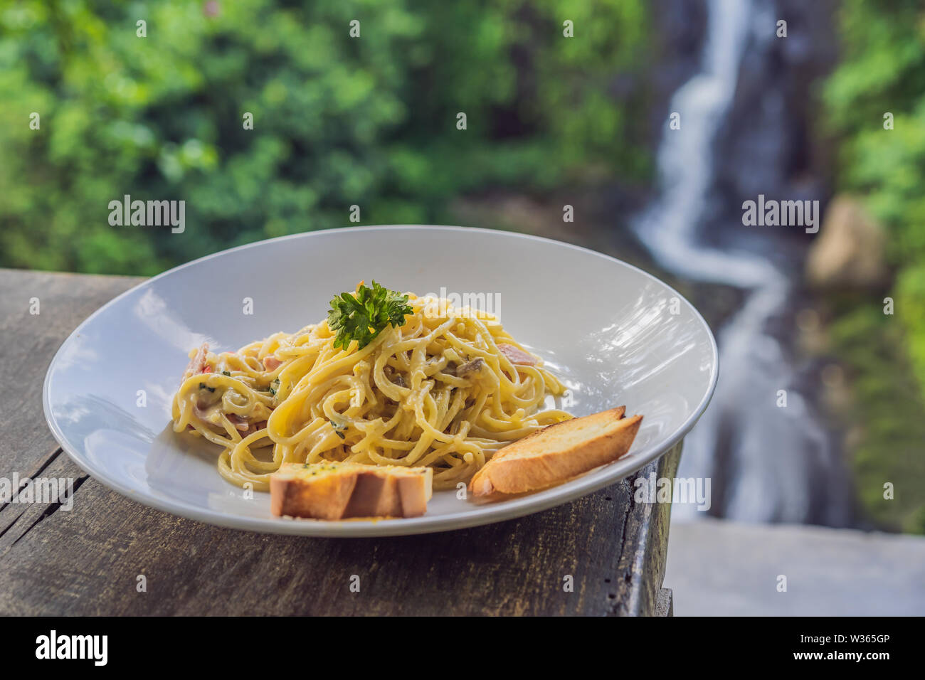 Pasta in a cafe on the background of a waterfall Stock Photo - Alamy
