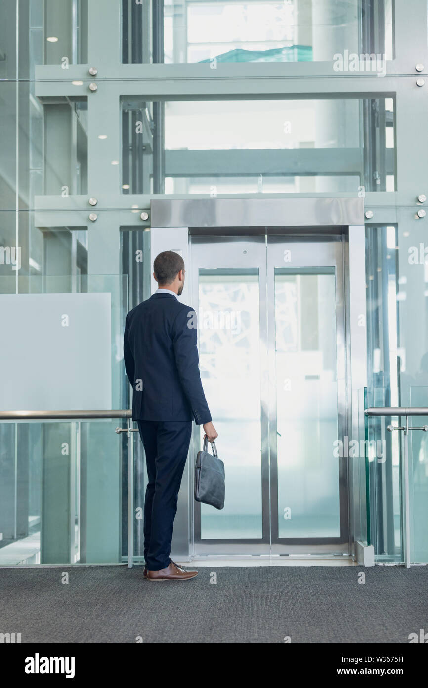Man waiting to use lift hi-res stock photography and images - Alamy