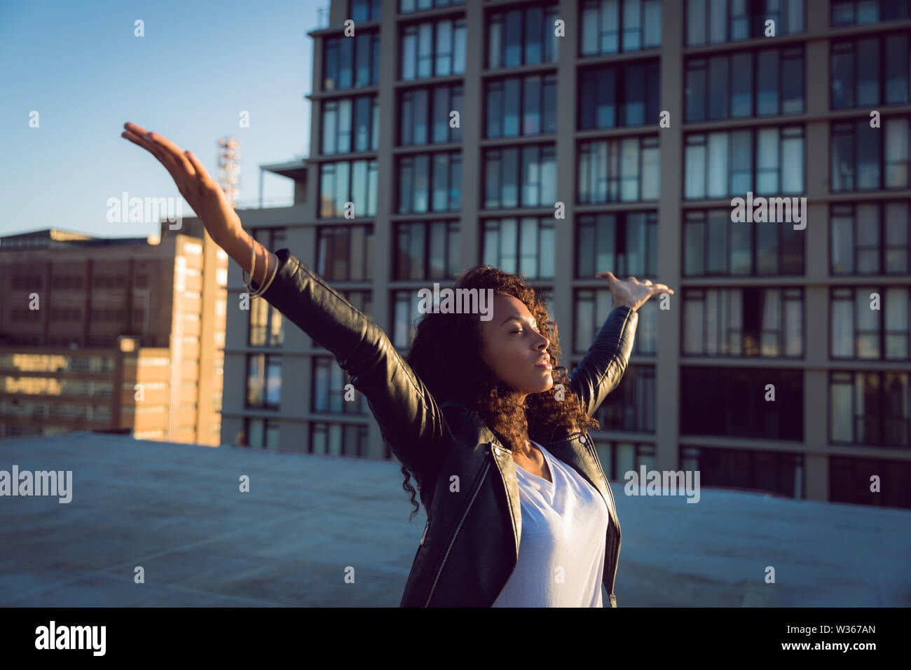 Young woman on a rooftop Stock Photo - Alamy