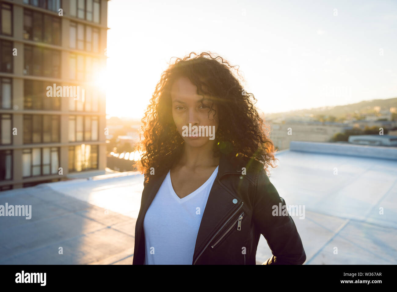 Young woman on a rooftop Stock Photo - Alamy