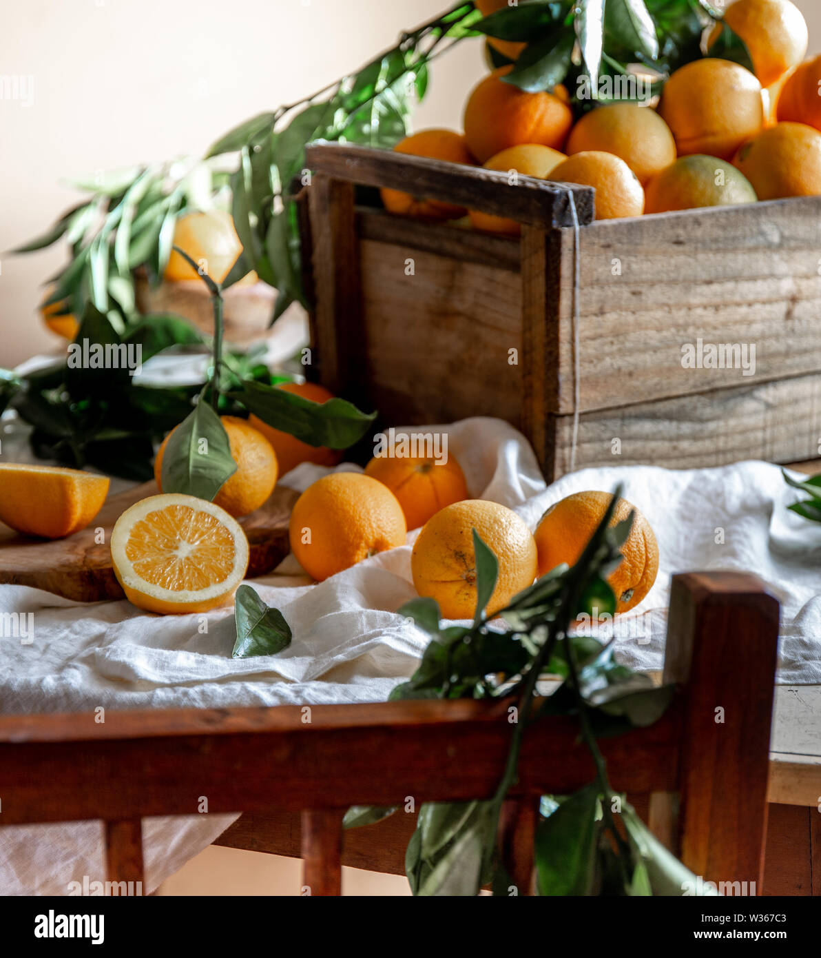 Table with box of fresh orange with orange tree branch and fresh orange ...