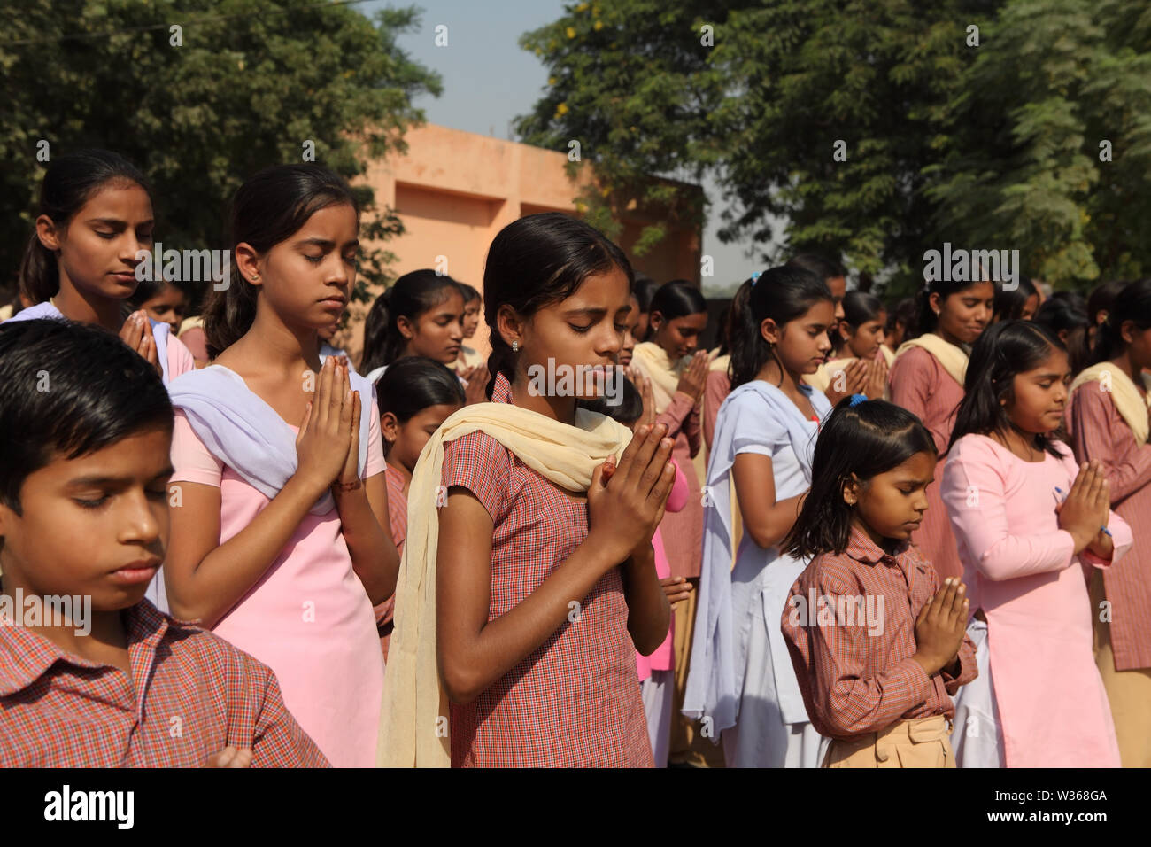 School children praying during assembly at school Stock Photo - Alamy