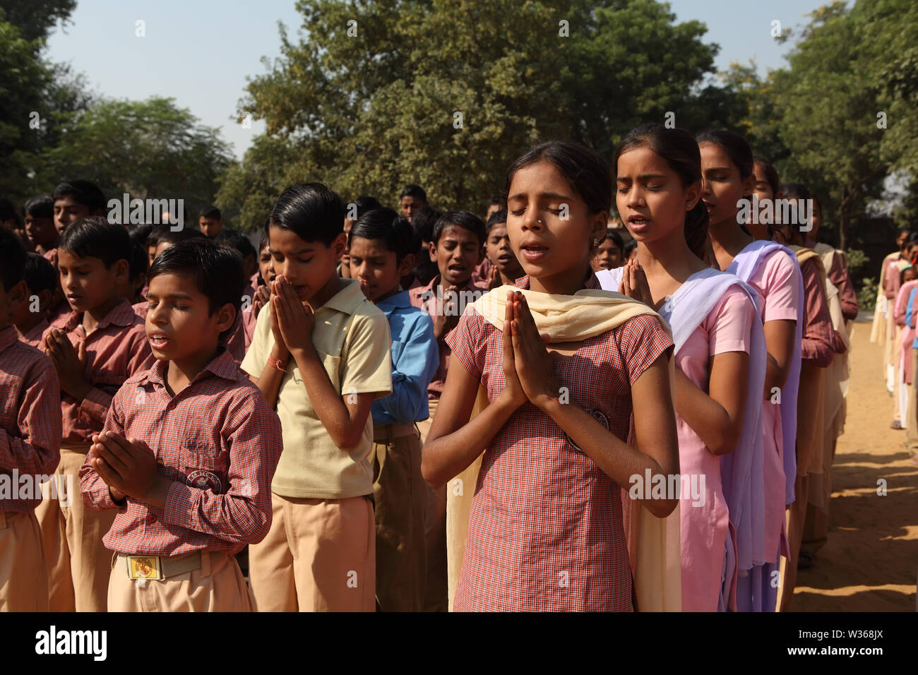 School children praying during assembly at school Stock Photo - Alamy
