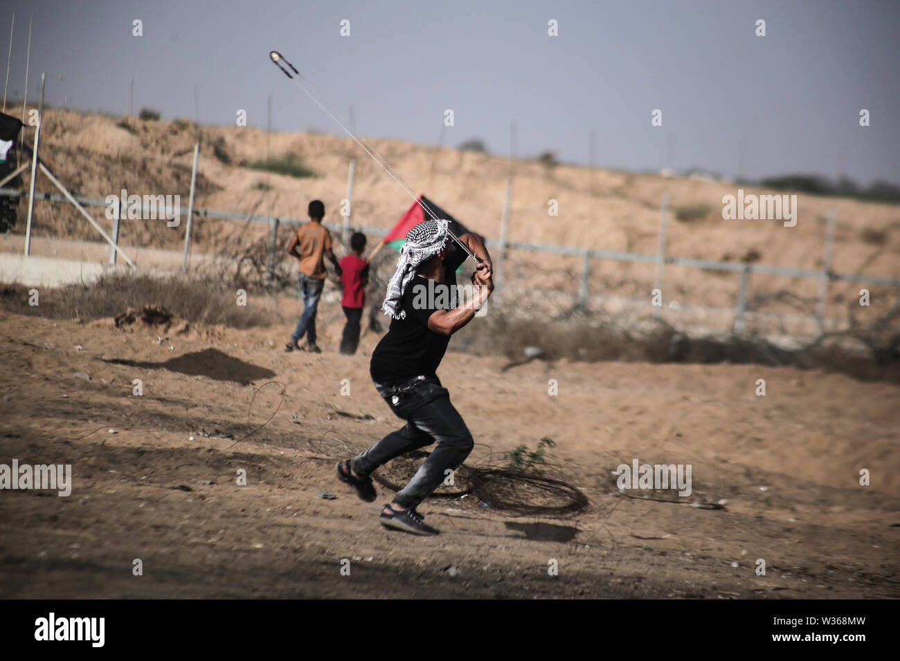Gaza, Palestine. 12th July, 2019. A Palestinian demonstrator uses a ...