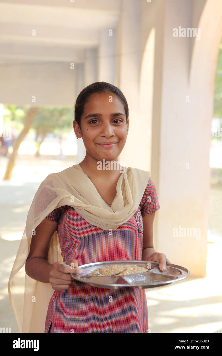 Portrait of a schoolgirl having Mid Day Meal in school Stock Photo - Alamy