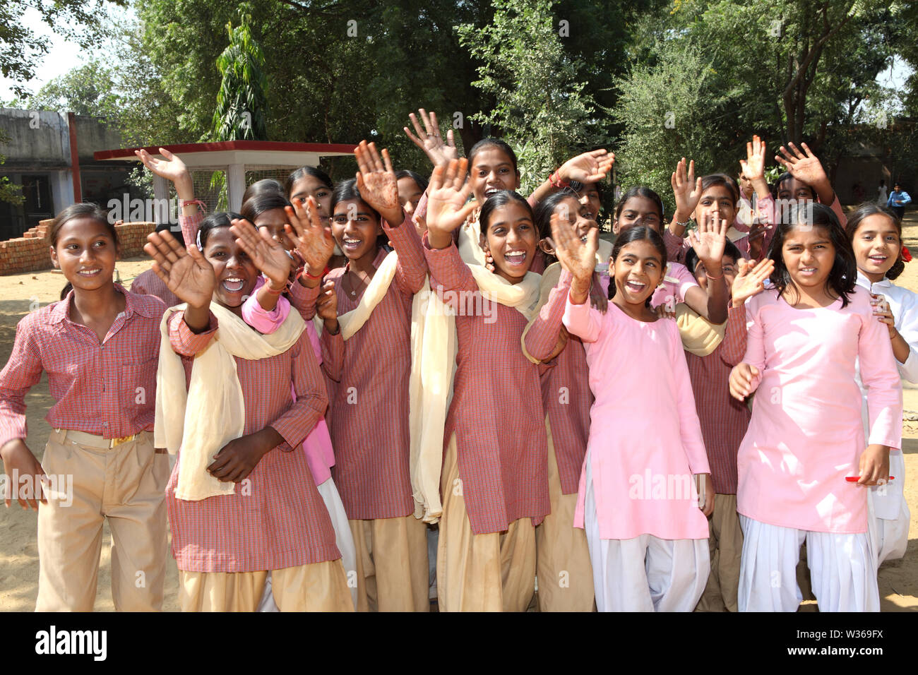 Group of school children waving hands Stock Photo - Alamy