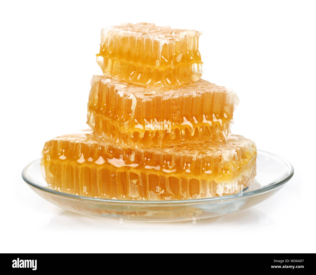 Honeycomb in glass dish isolated on white background Stock Photo - Alamy
