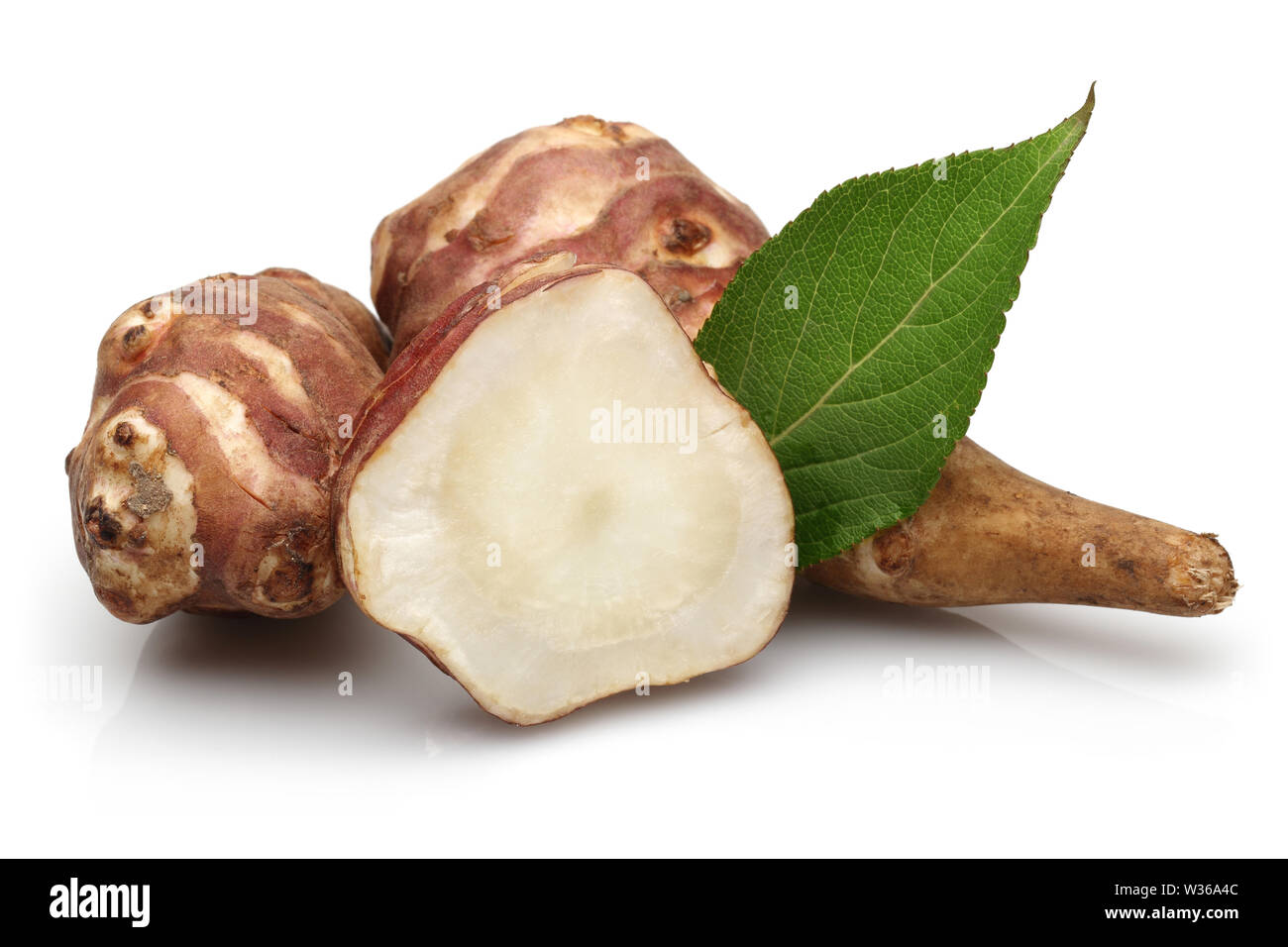 Jerusalem artichoke or sweet potato with slices and leaf isolated on ...