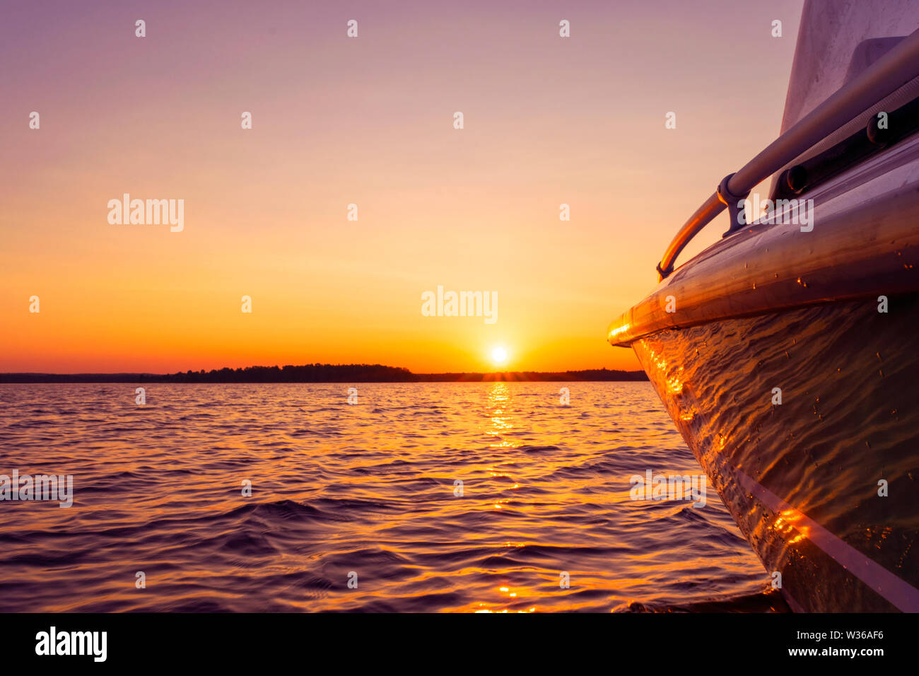 Side view Speeding fishing motor boat with drops of water. Blue ocean ...