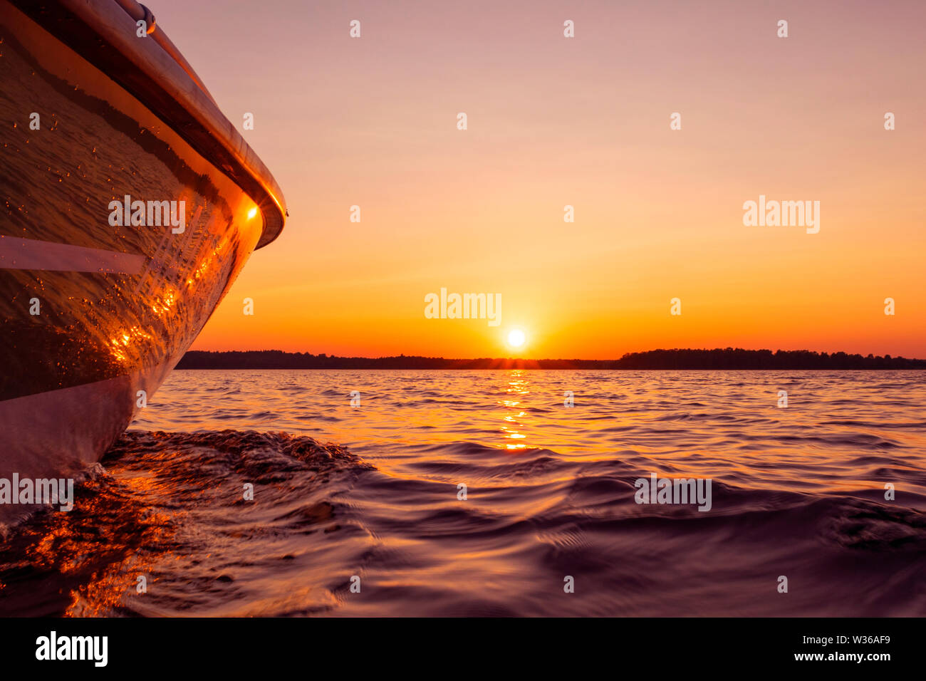 Side view Speeding fishing motor boat with drops of water. Blue ocean ...