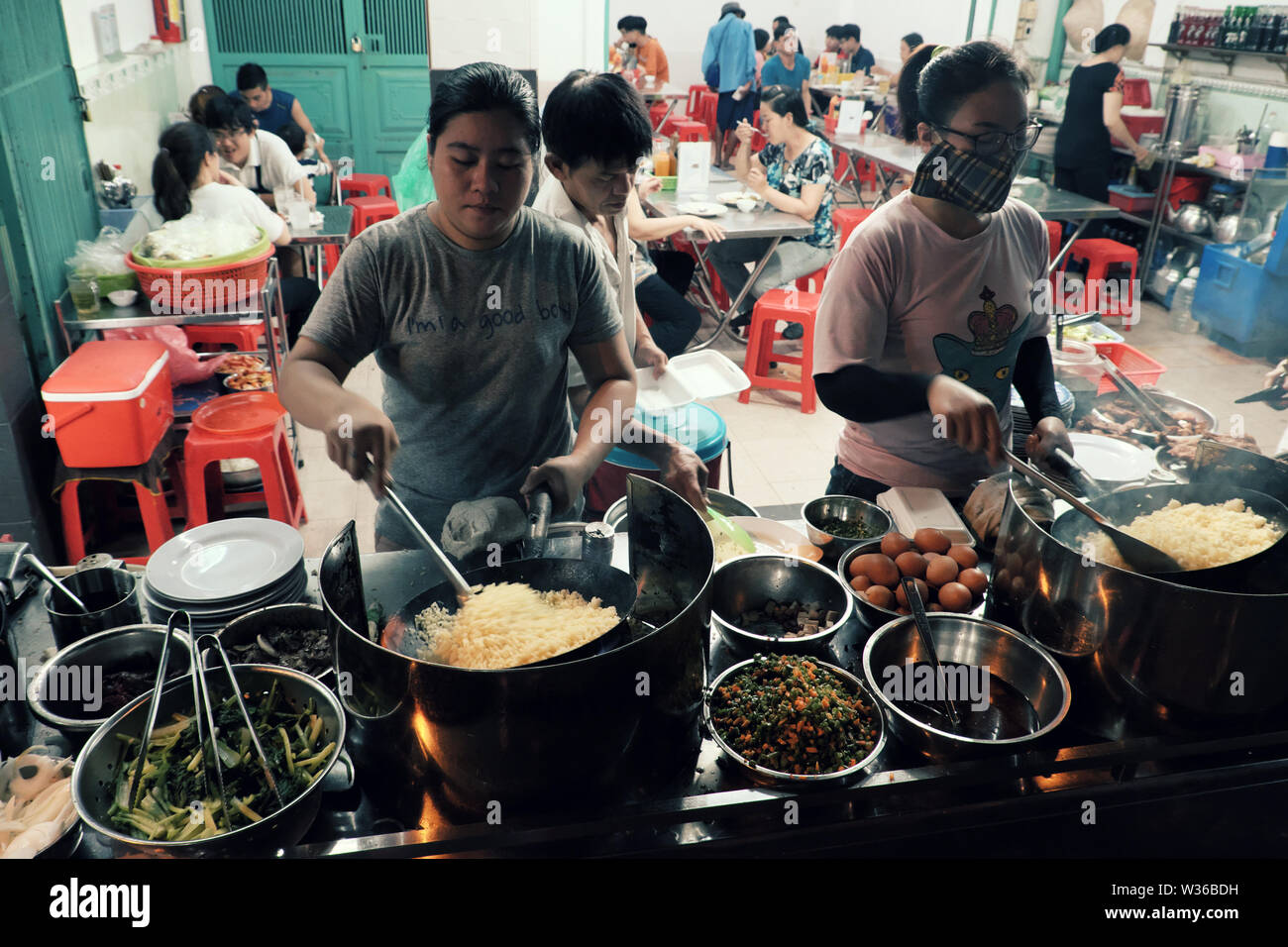 Female chef making chicken rice for diners at restaurant at night food ...