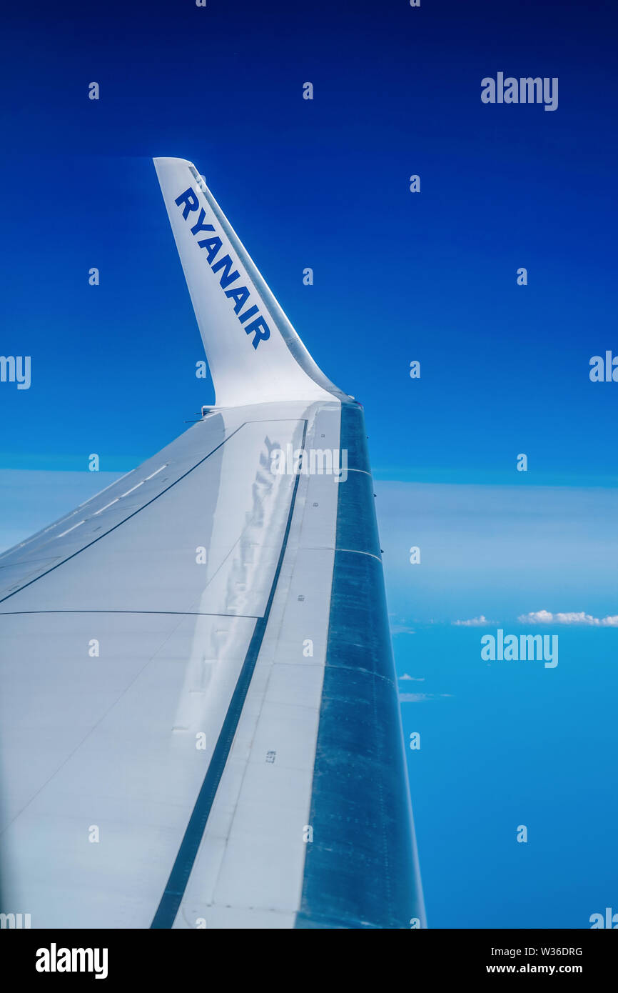 London, UK - June 19, 2019: Boeing 737 aircraft wing and blue sky ...
