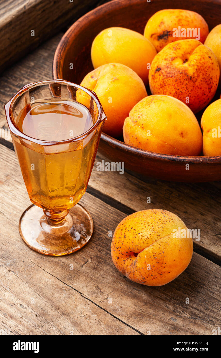 Ripe apricot wine.Alcoholic drink.Fruit wine or liquor in glass Stock ...