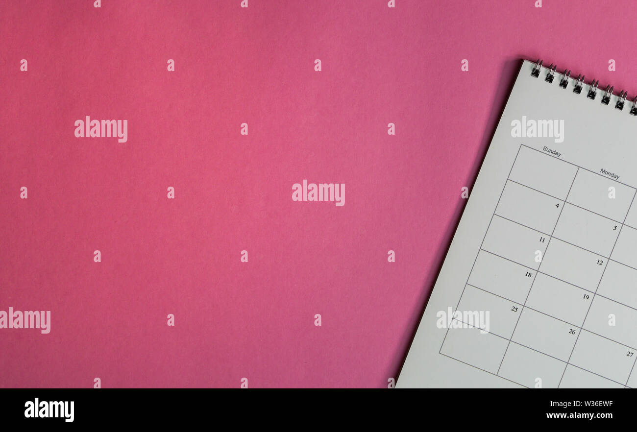 Calendar or planner on pink background with copy space. Business ...