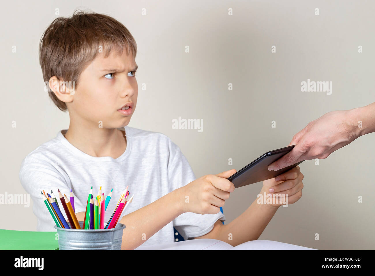 Video games addiction. Mother taking tablet away from the kid hands ...
