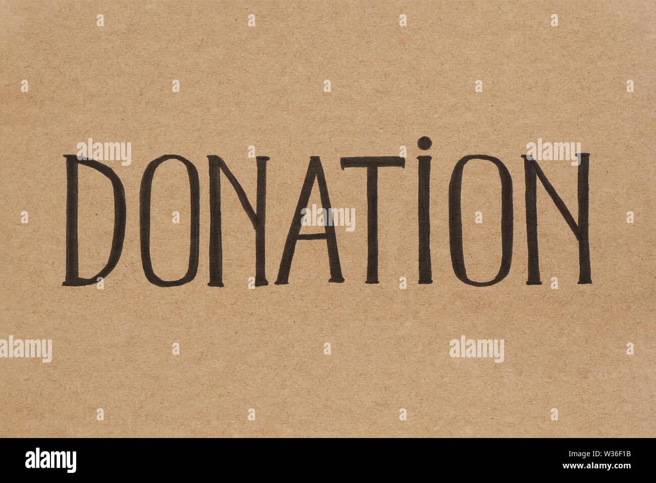 Word DONATION written by hand on cardboard. Handwritten lettering Stock ...