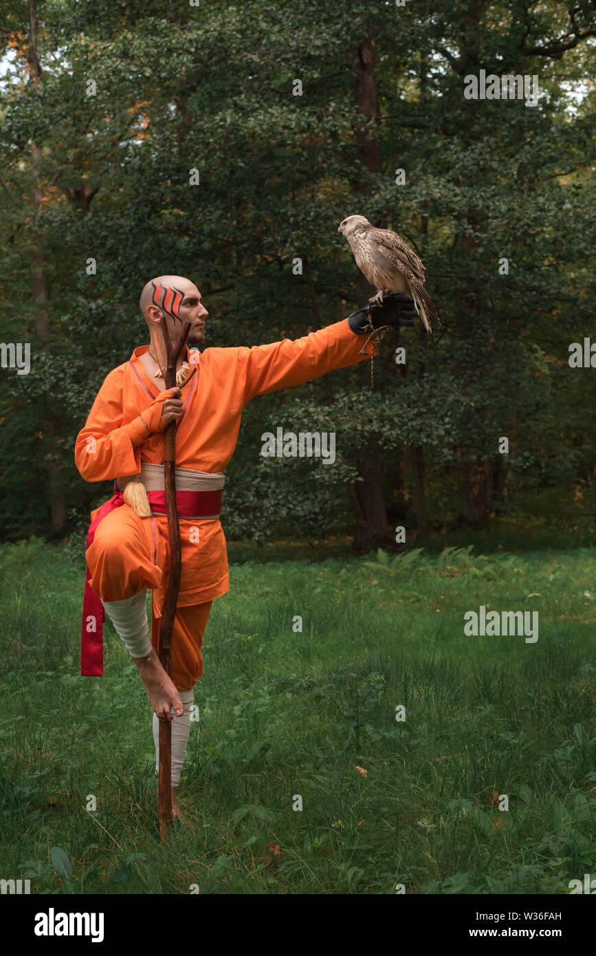 Buddhist monk with a bird on his hand in the forest in the summer Stock ...