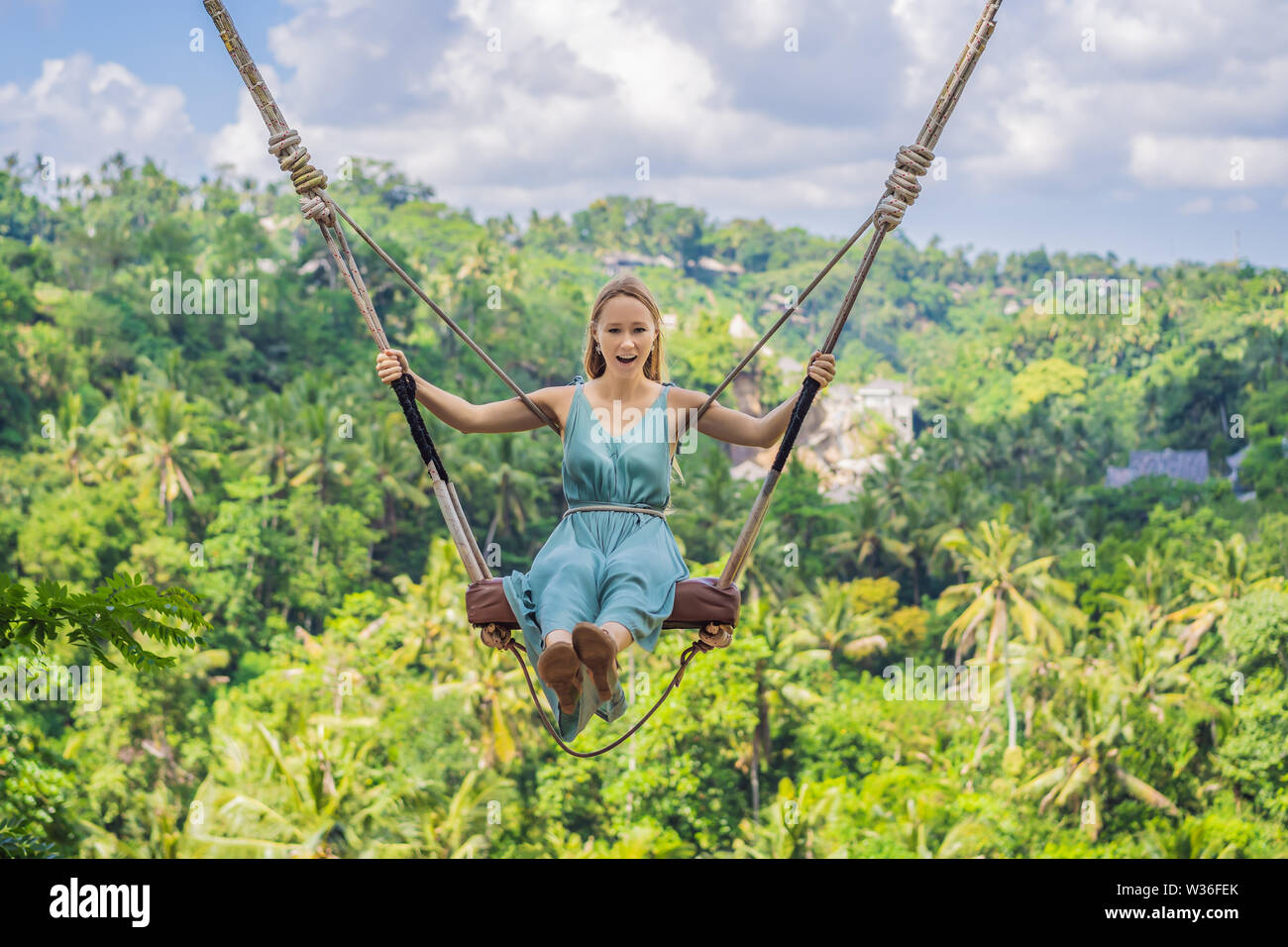 Young woman swinging in the jungle rainforest of Bali island, Indonesia ...