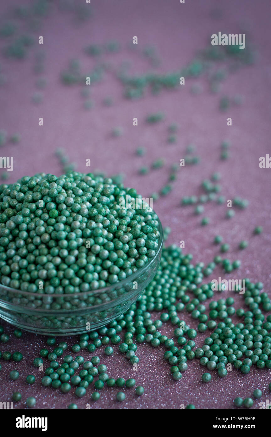 Green ball crystal sugar sprinkle dots, on glitter pink background ...
