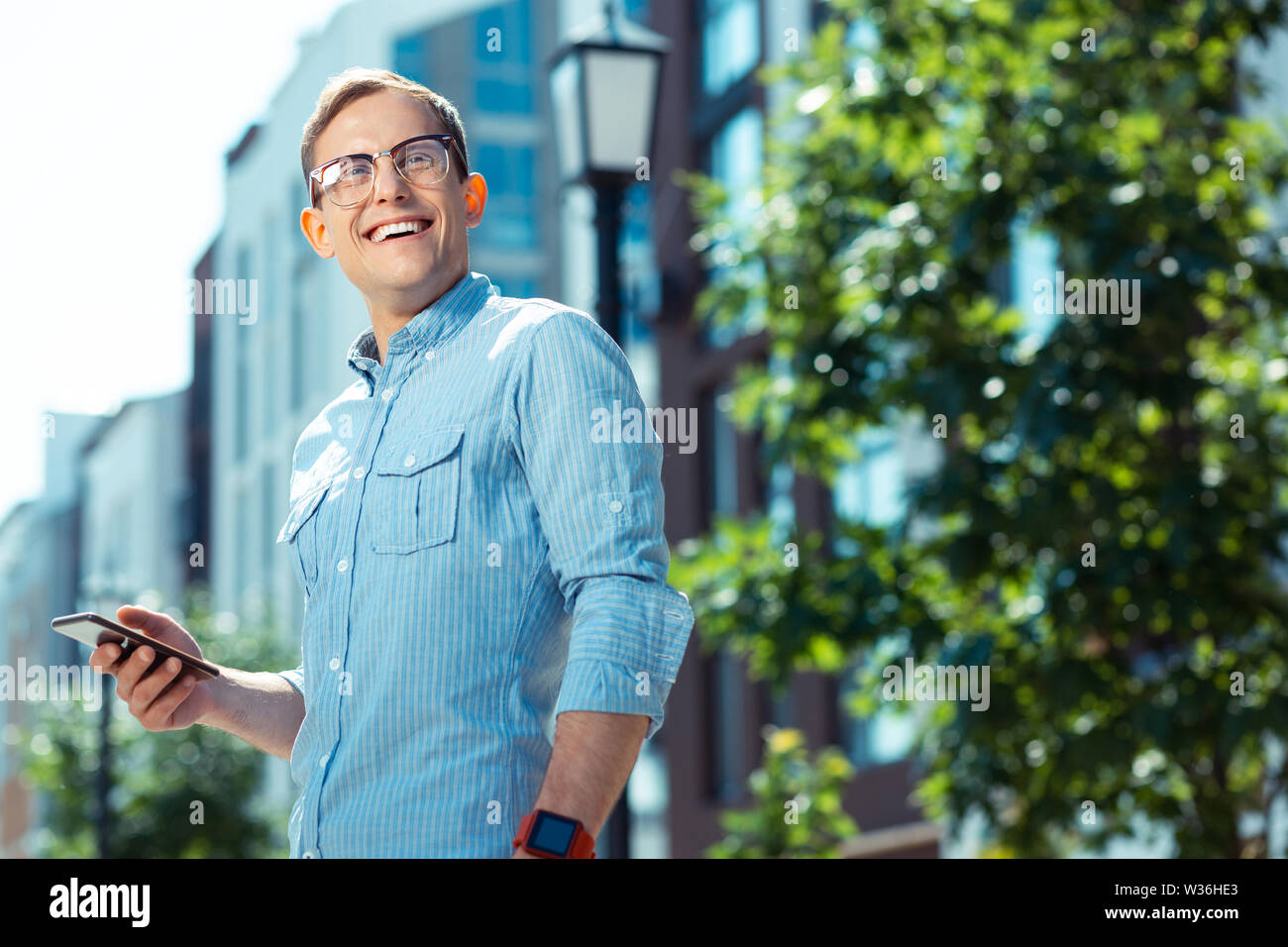 Handsome businessman smiling broadly while enjoying weekend walk Stock ...