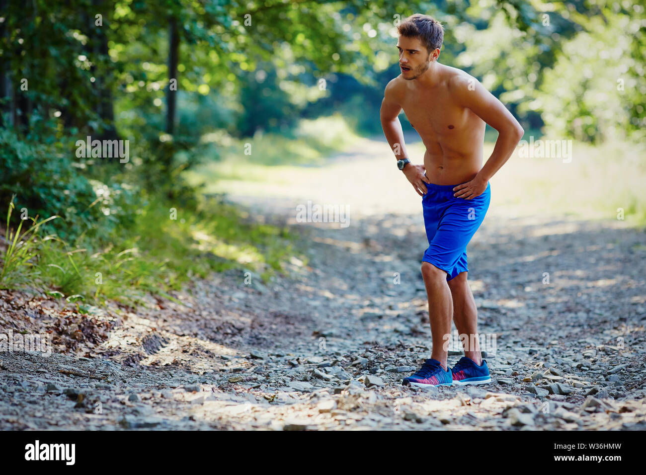 Young man resting during trial running Stock Photo - Alamy