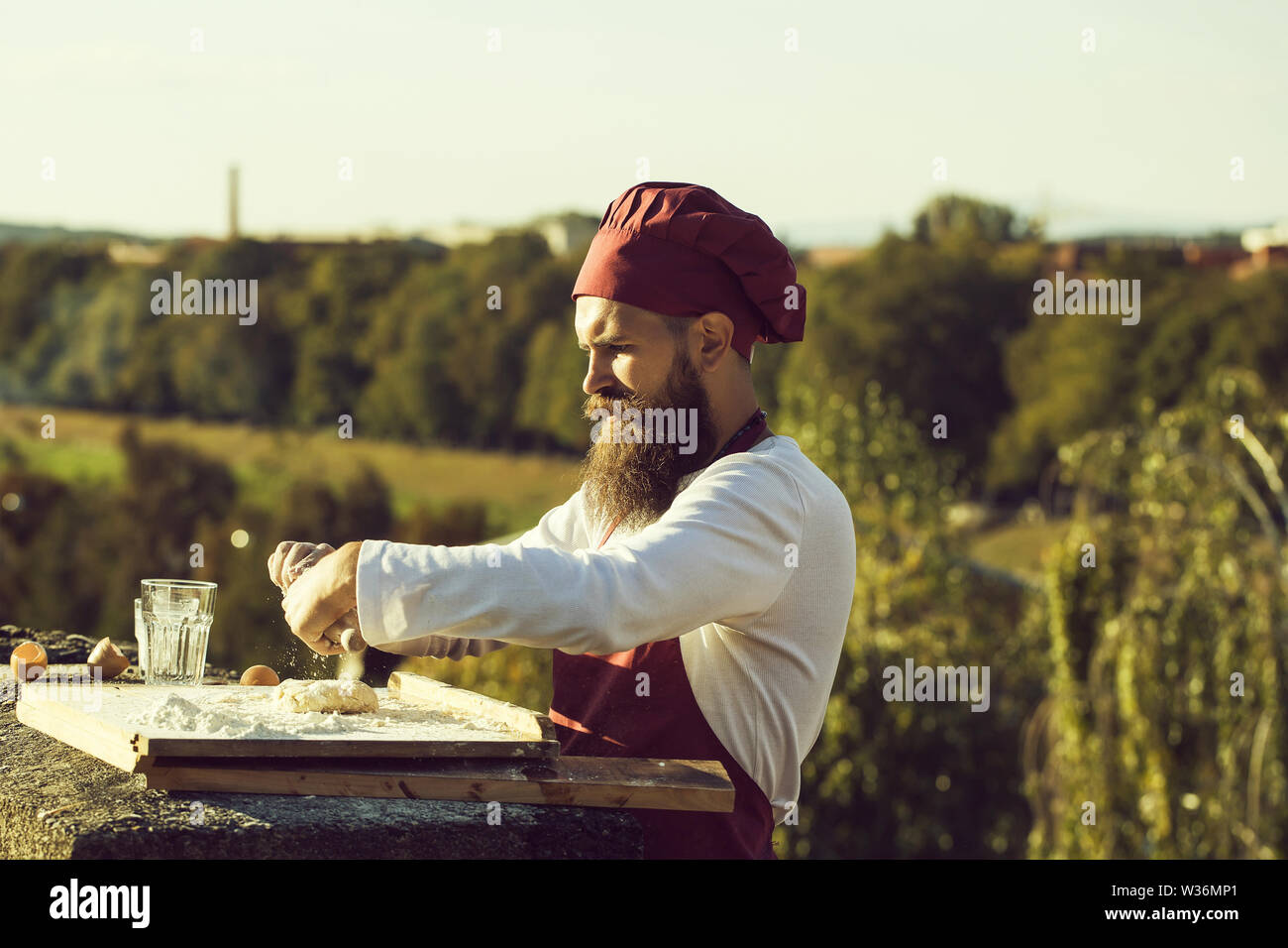Man cook chef with beard on handsome face in white and red uniform ...