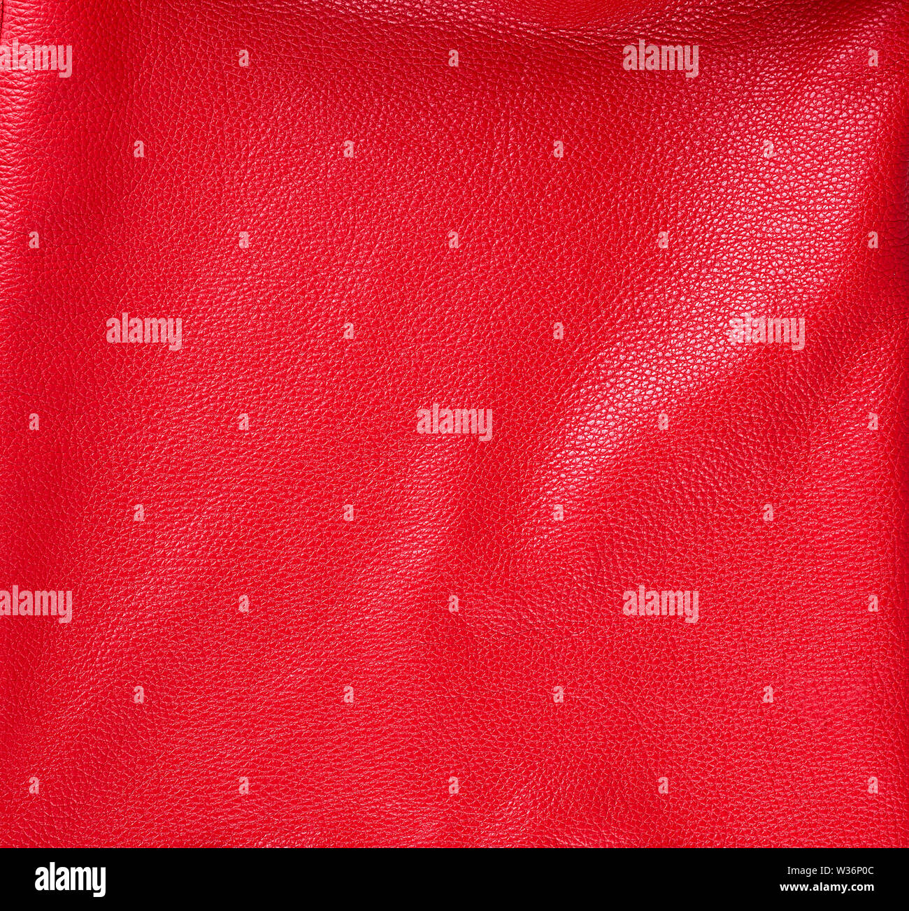 natural bright red cowhide texture, full frame, scarlet color, close up ...