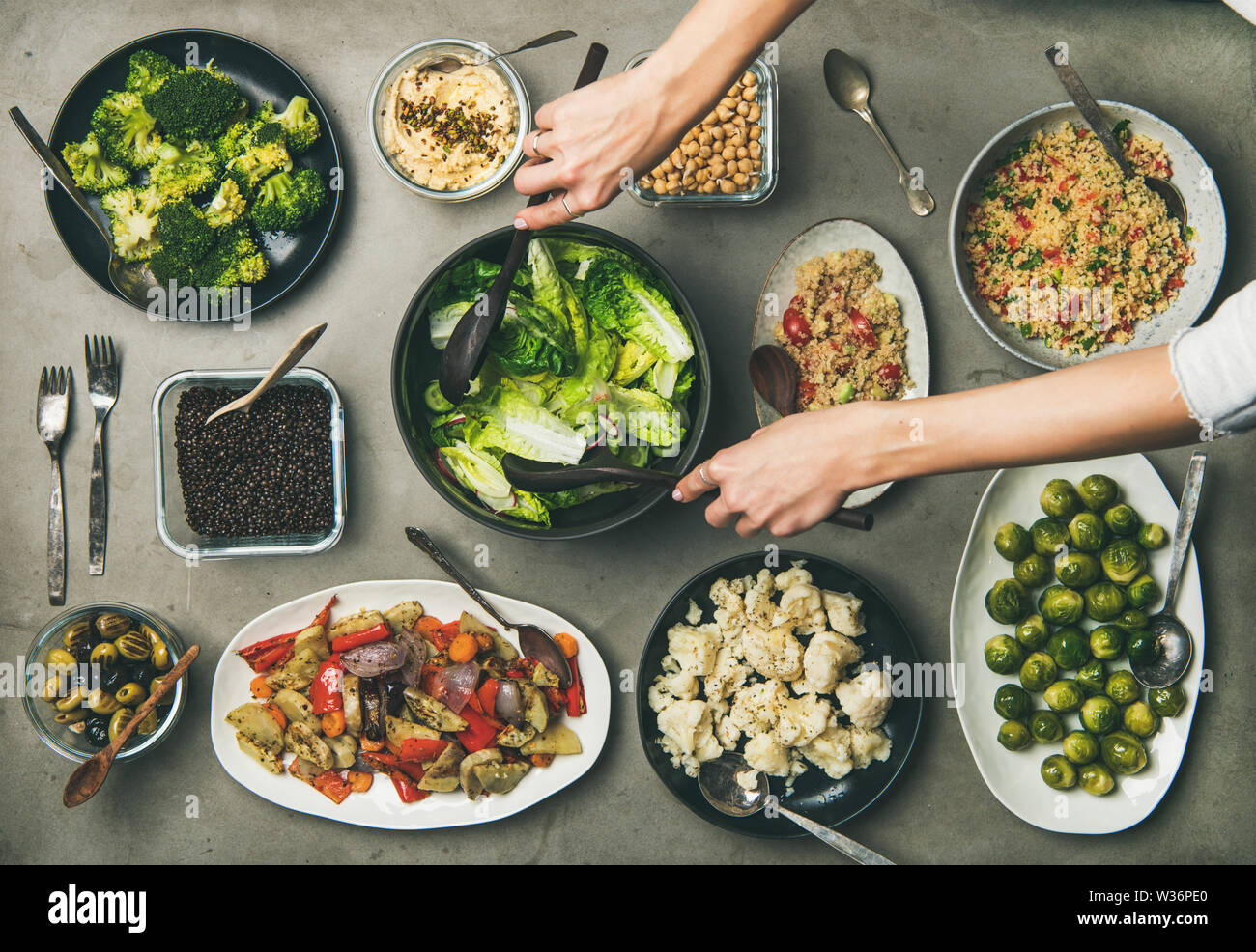 Vegan dinner table setting. Healthy vegetarian dishes in plates on ...