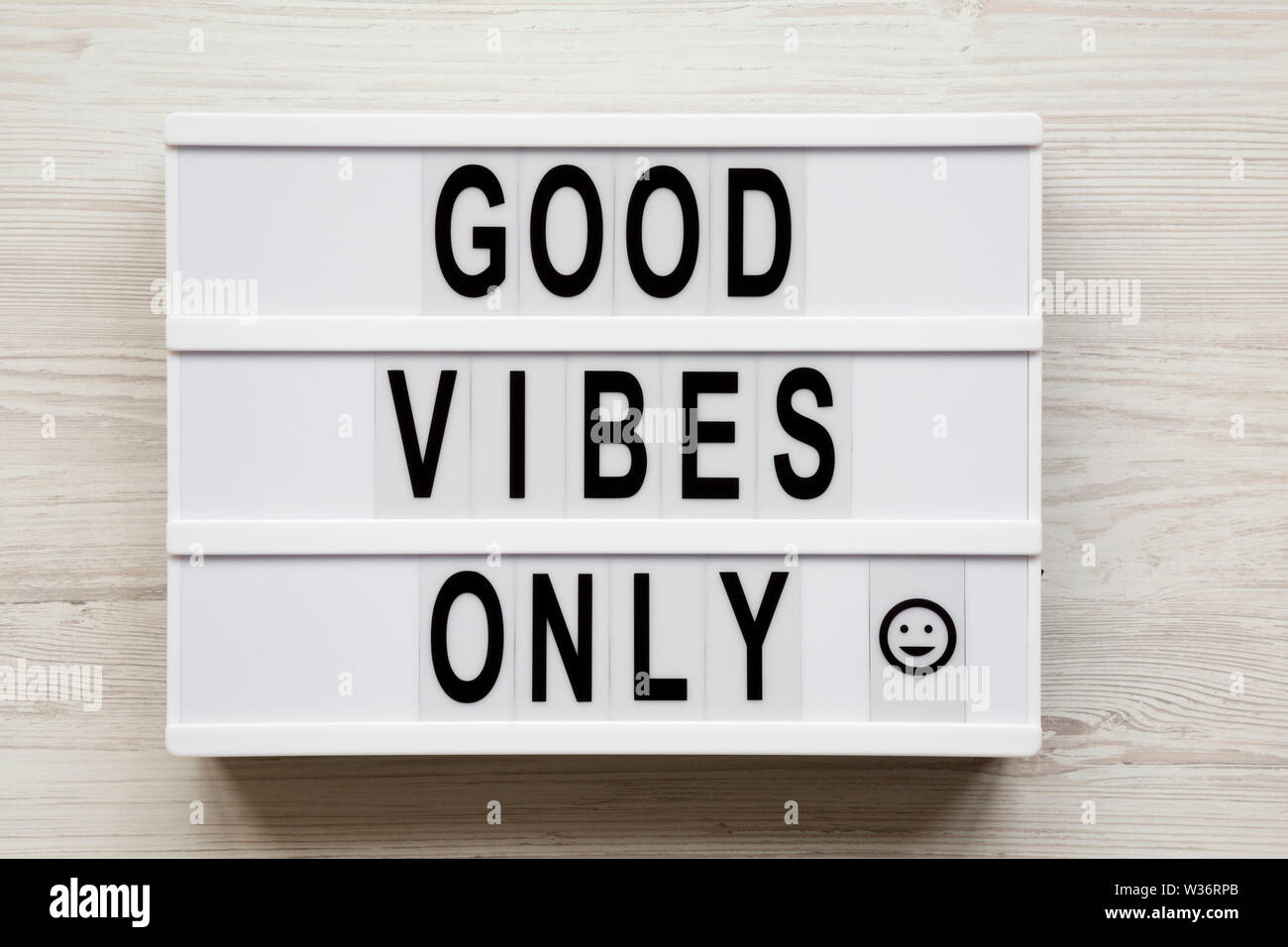 'Good vibes only' words on a modern board on a white wooden background ...