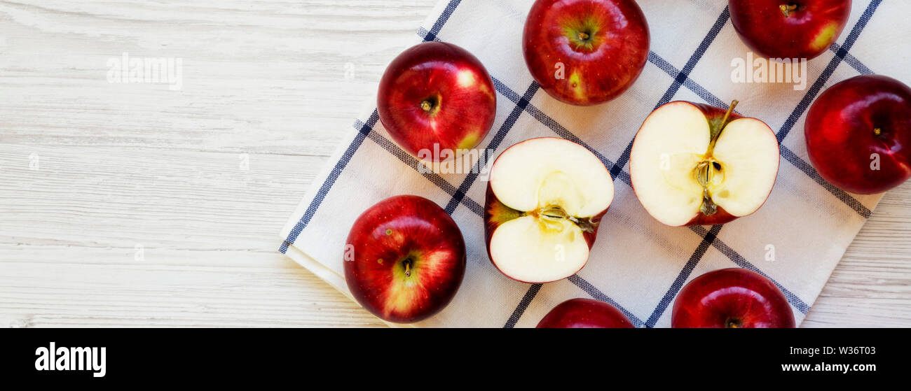 Fresh raw red apples on a white wooden background, top view. Flat lay ...