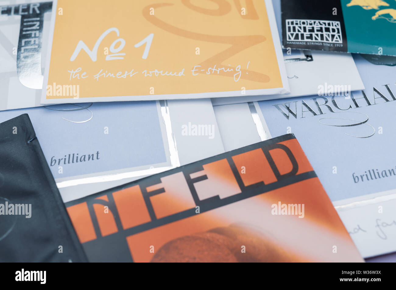 mixed violin string packs on a pink colored surface Stock Photo - Alamy