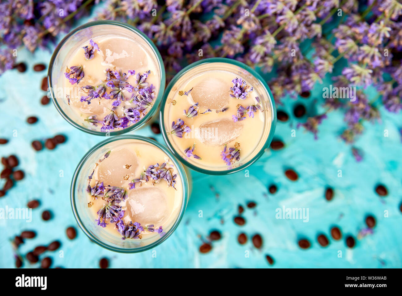 Summer drink iced coffee with lavender in glass and coffee beans on ...