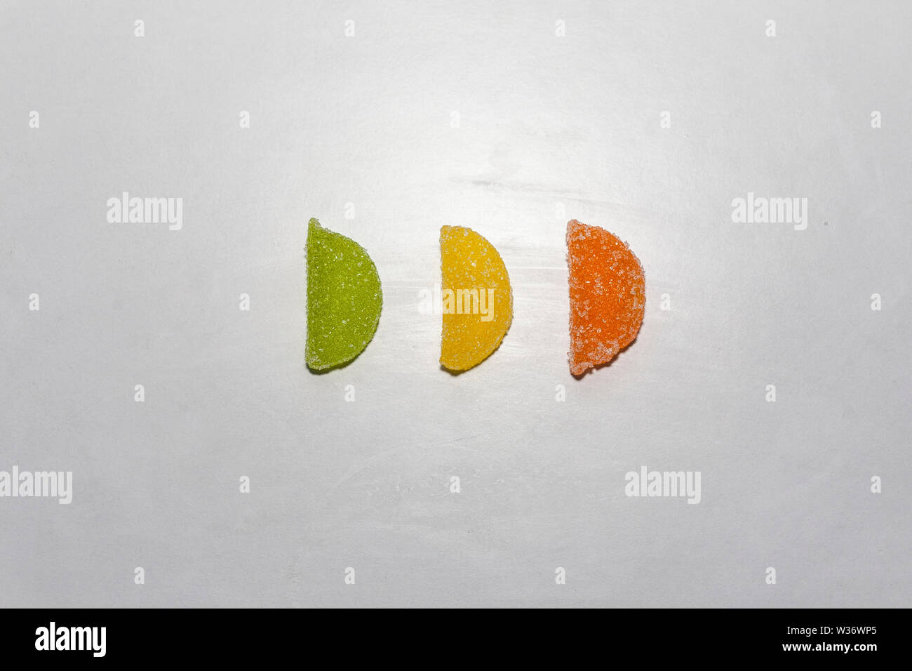 Three Sugar candies in a row Stock Photo - Alamy
