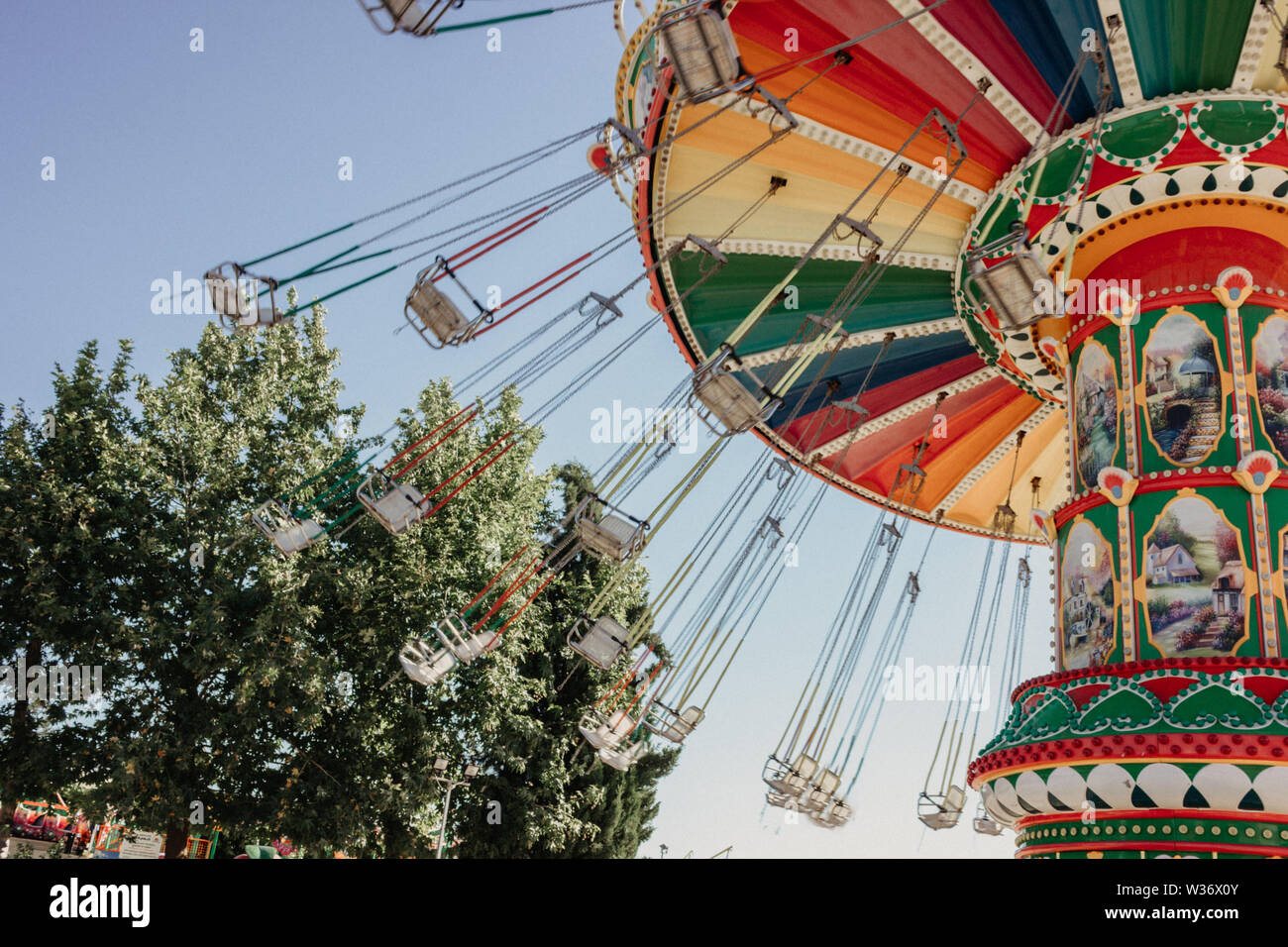 Carousel with chains in an amusement park on summer sunny day Stock ...