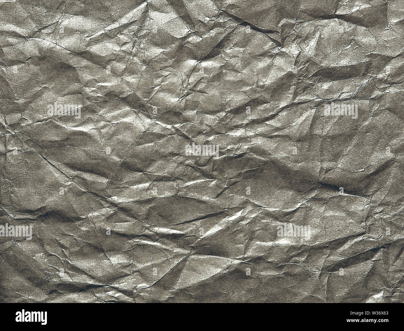 silver crumpled paper as a background Stock Photo - Alamy