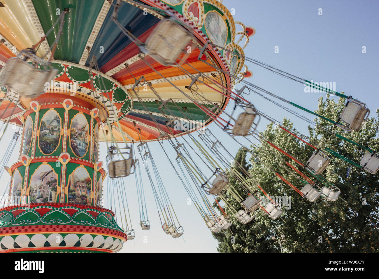 Carousel with chains in an amusement park on summer sunny day Stock ...