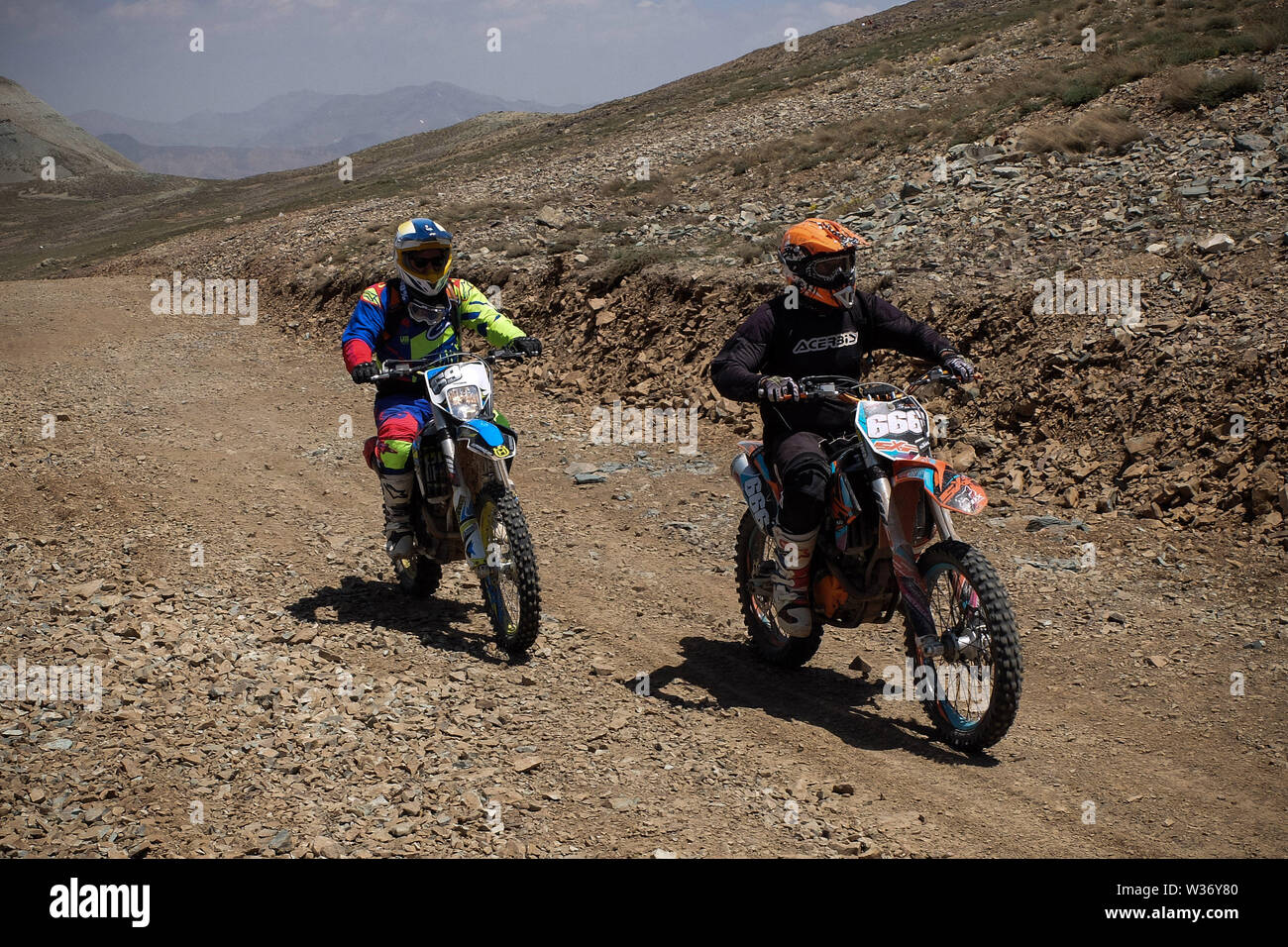 Tehran, Iran. 12th July, 2019. Two men riding motorcycles at Tochal ...