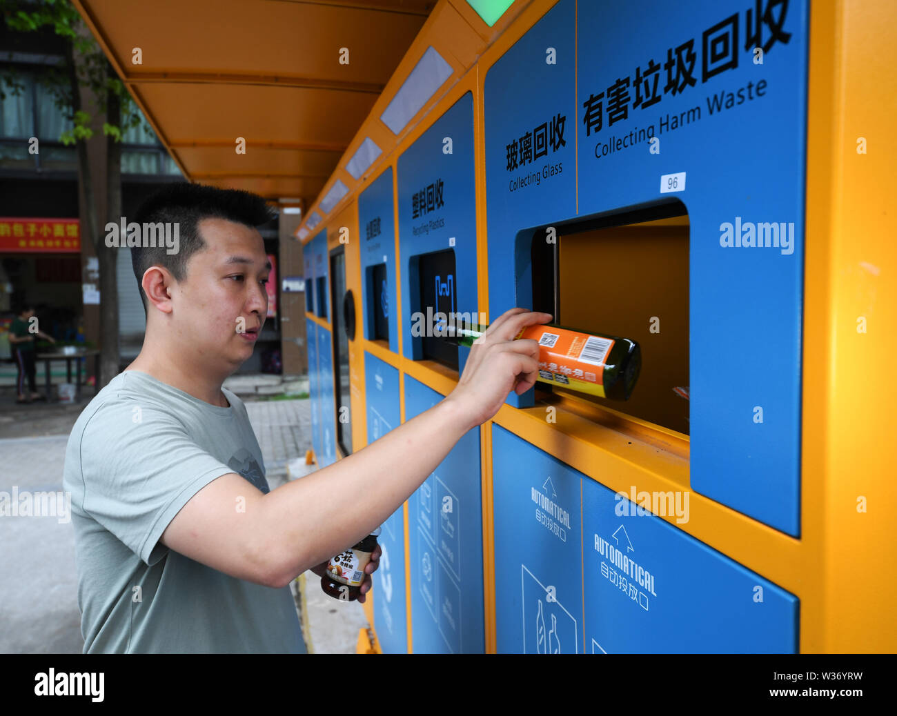 Beijing, China. 4th July, 2019. A resident puts a glass bottle into a ...
