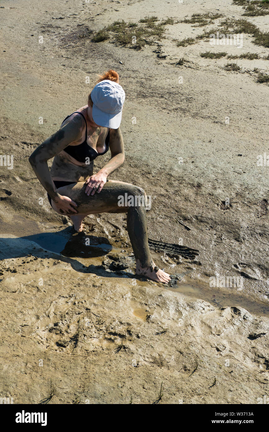 Woman smeared mud on beach hi-res stock photography and images - Alamy