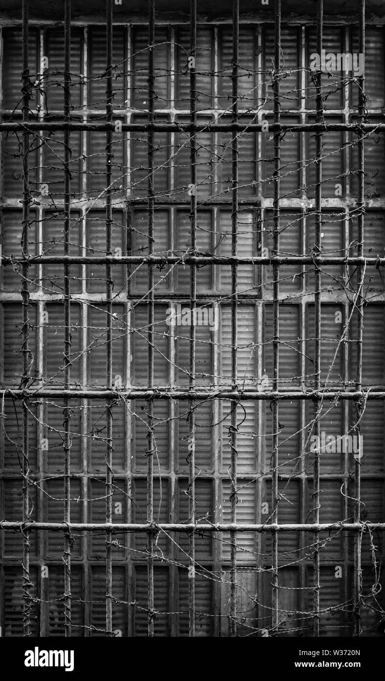 window with bars and barbed wire Stock Photo - Alamy