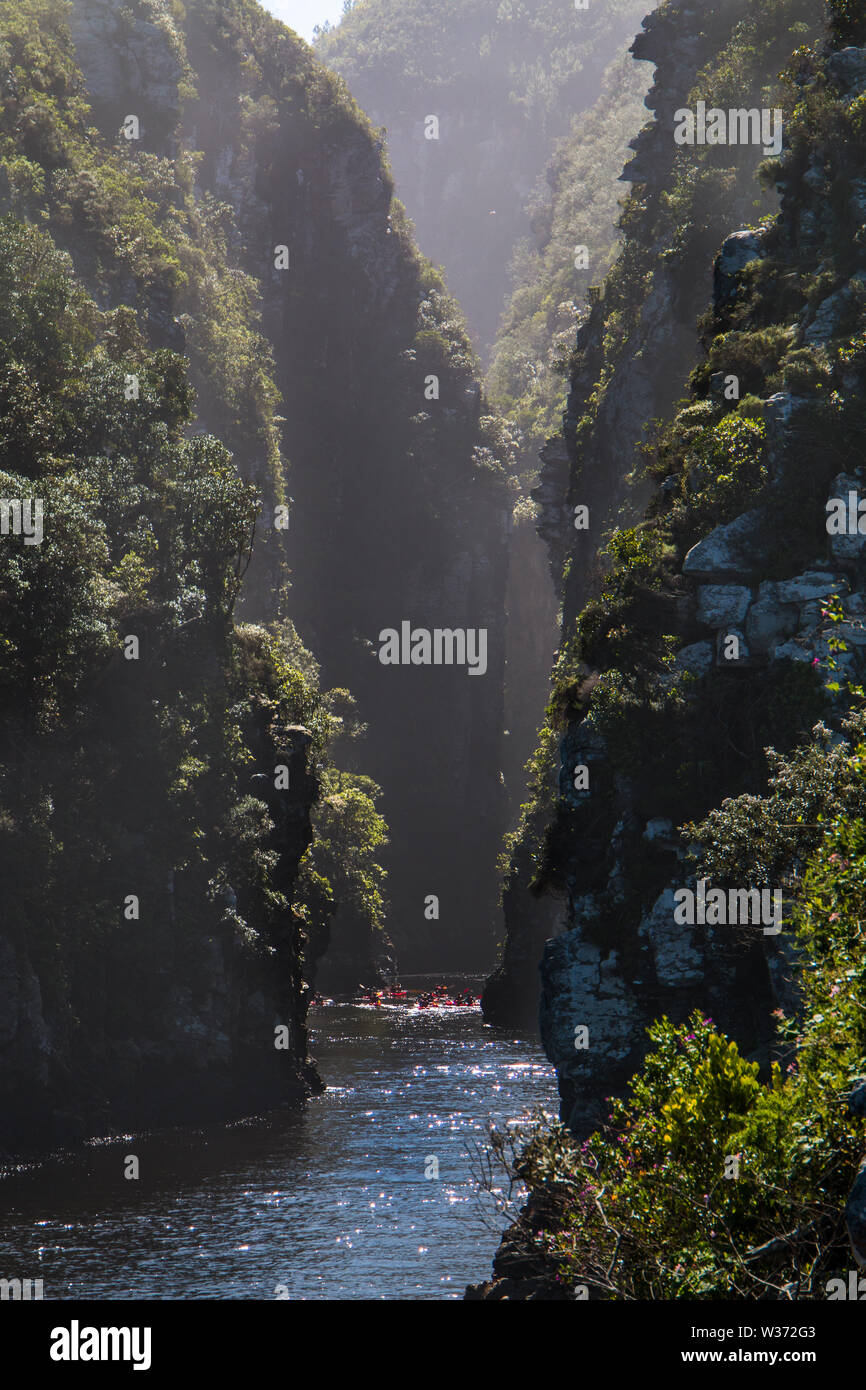 Deep river gorge nature landscape with group of people on canoes in the ...