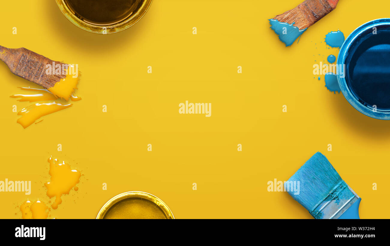 Creative painting composition with color brushes and boxes on yellow ...