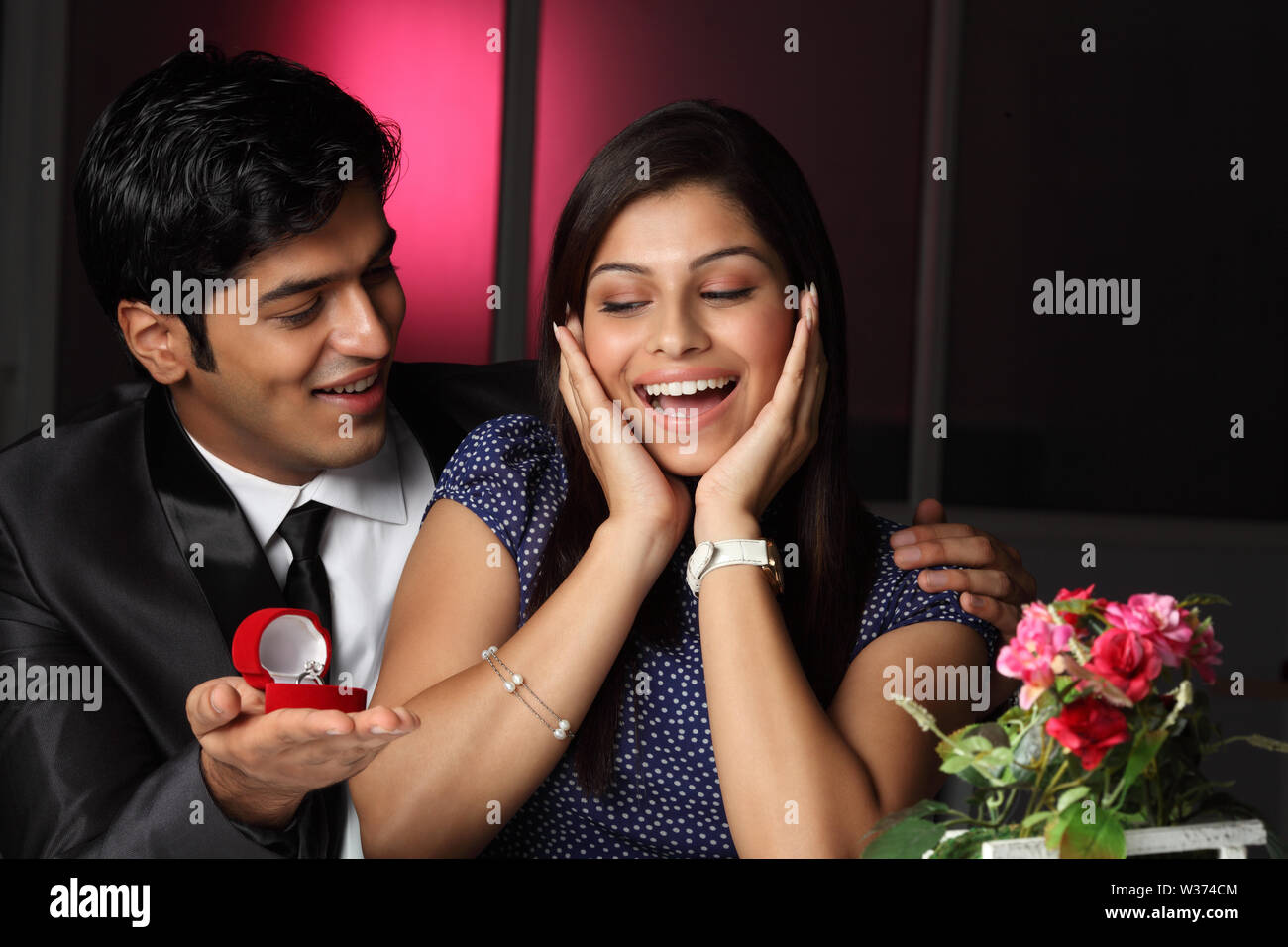 Man giving engagement ring to a woman Stock Photo - Alamy