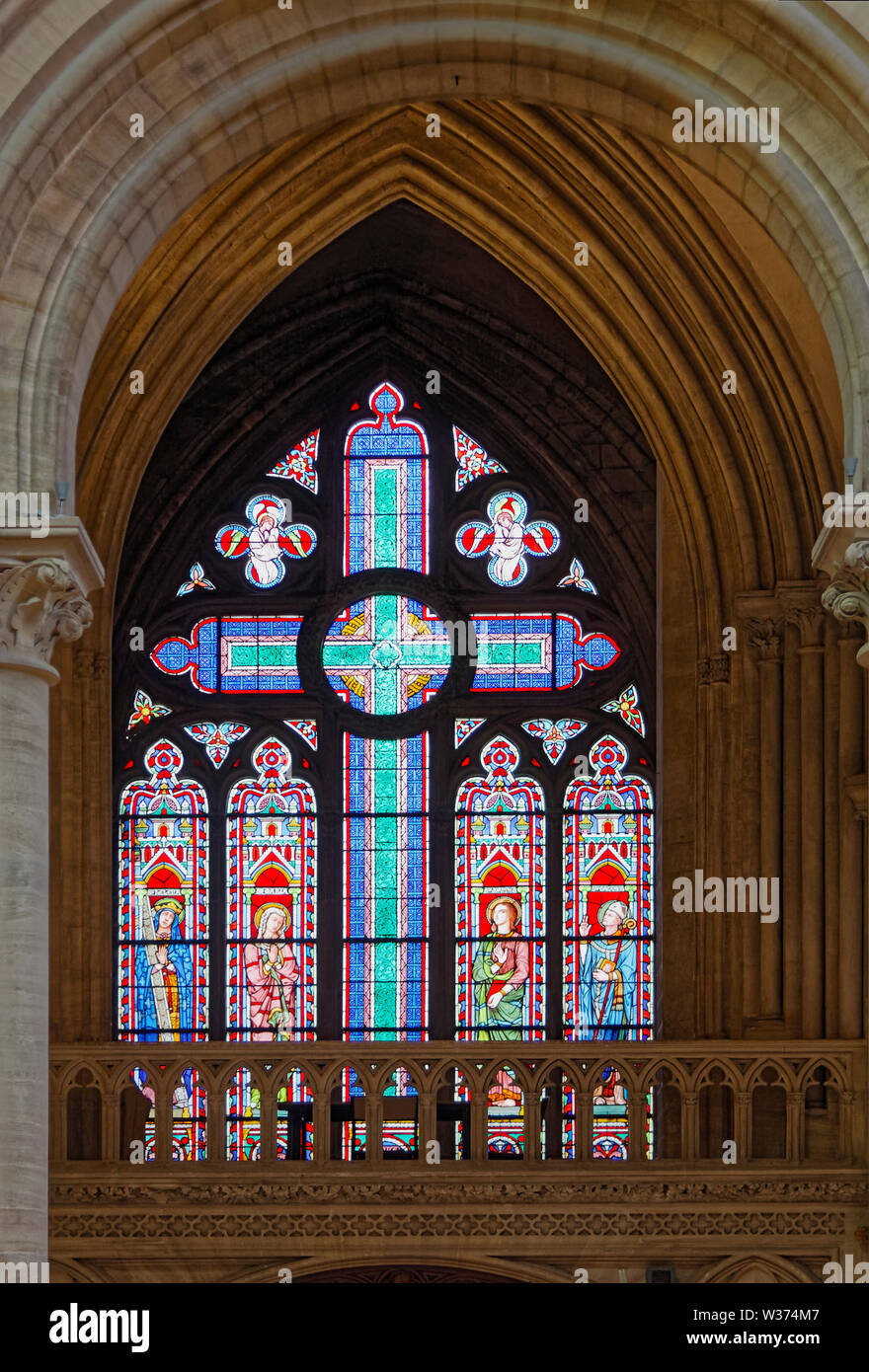 Notre Dame Cathedral; arched stained glass window, cross, religious art ...