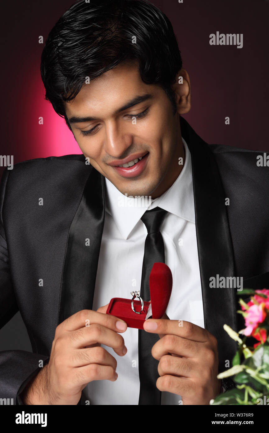 Man holding engagement ring Stock Photo - Alamy
