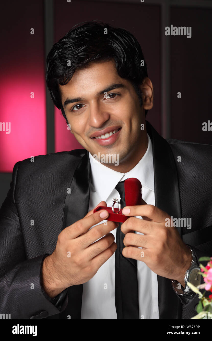 Man holding engagement ring Stock Photo - Alamy