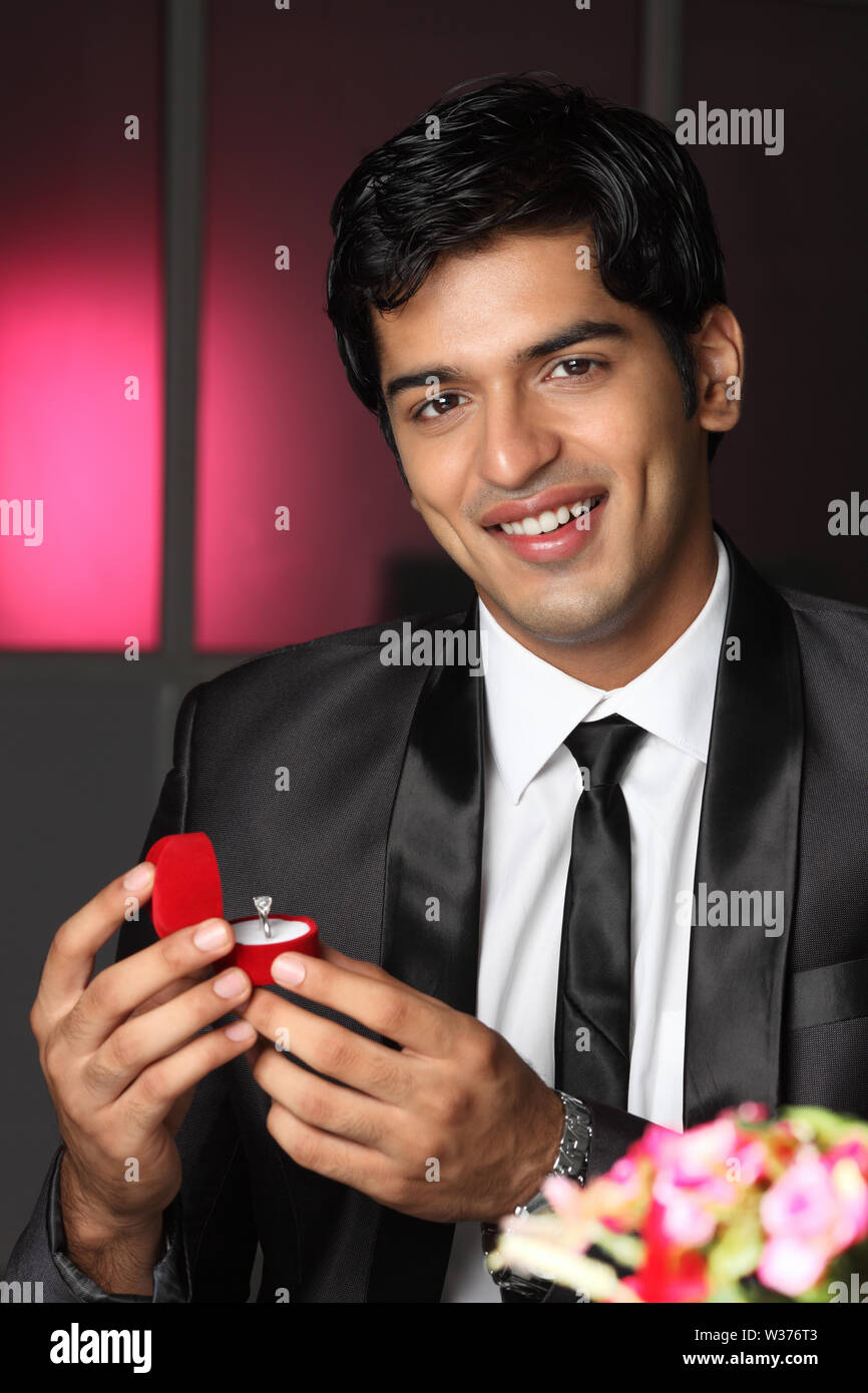 Man holding engagement ring Stock Photo - Alamy