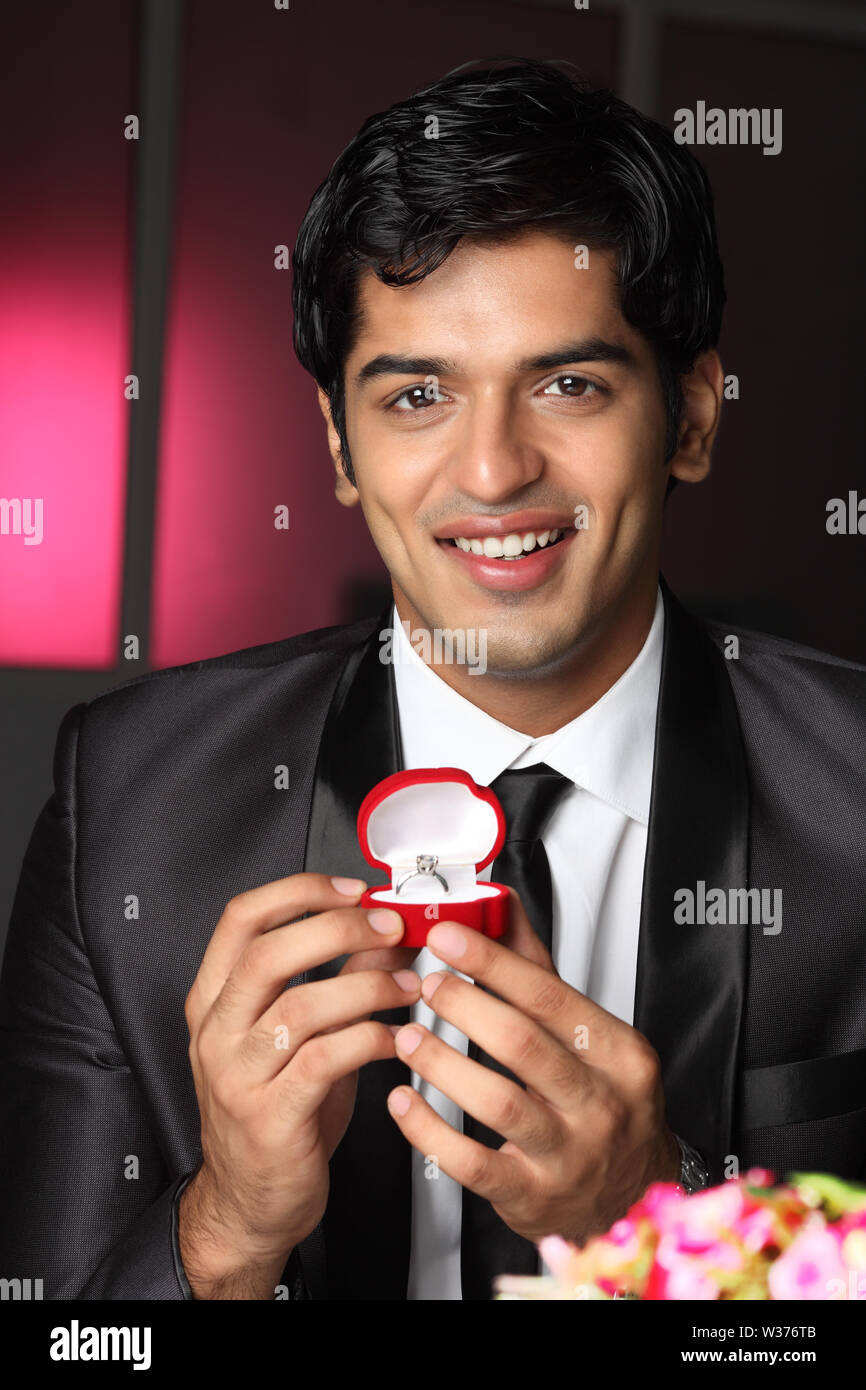 Man holding engagement ring Stock Photo - Alamy