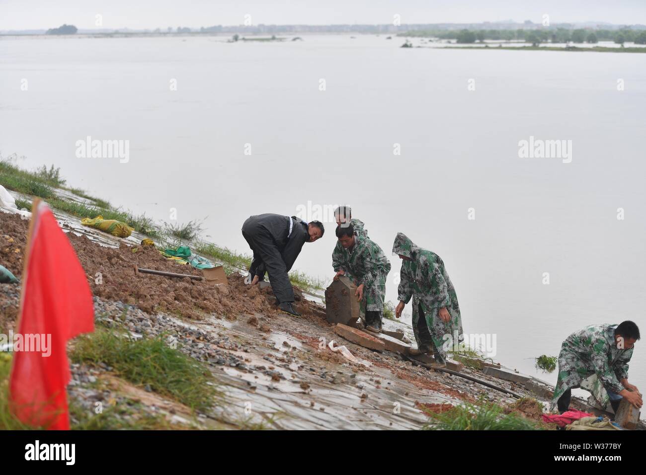 Yugan, China's Jiangxi Province. 13th July, 2019. People work to ...