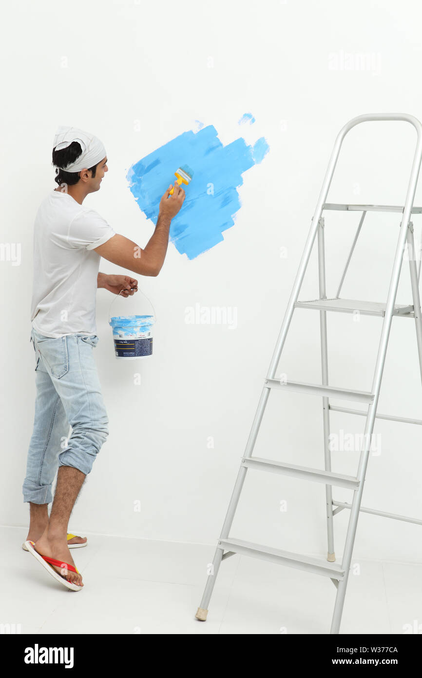 Man painting a wall Stock Photo - Alamy
